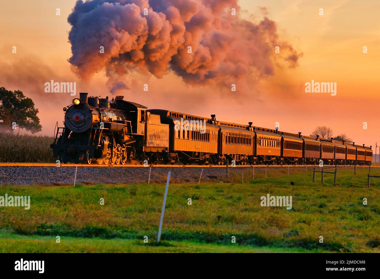 View of Golden Steam Passenger Train at Sunrise Stock Photo - Alamy