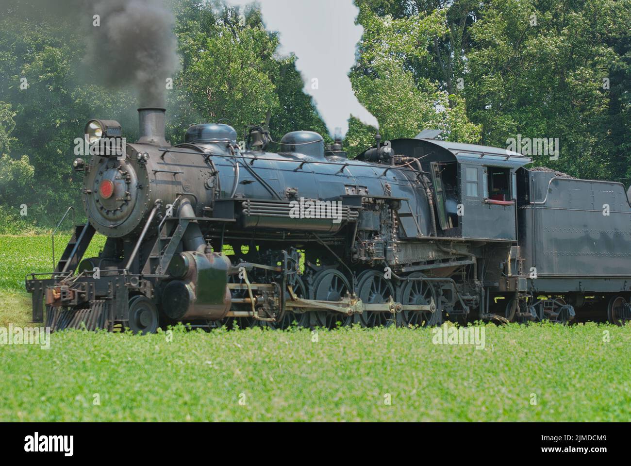 Close Up of an Antique Steam Passenger Train Puffing Along Stock Photo ...