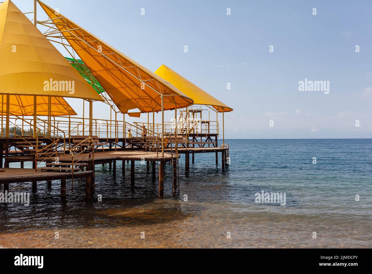 Swimming area or pier on the sea. A large pier with a roof, wooden ...