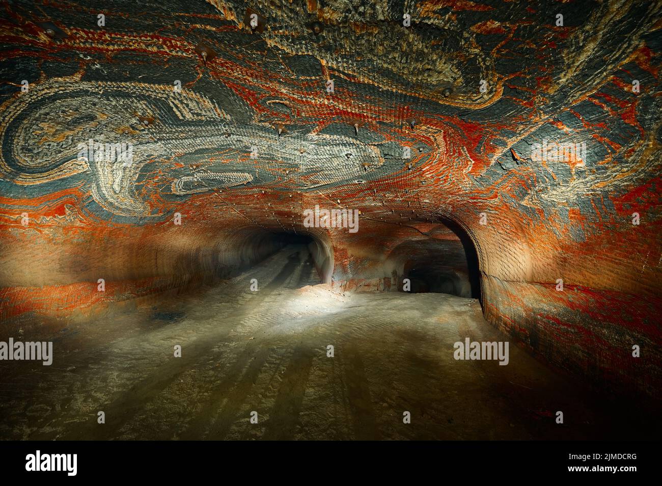 Outgoing tunnel of salt quarry with red patterns on walls Stock Photo ...