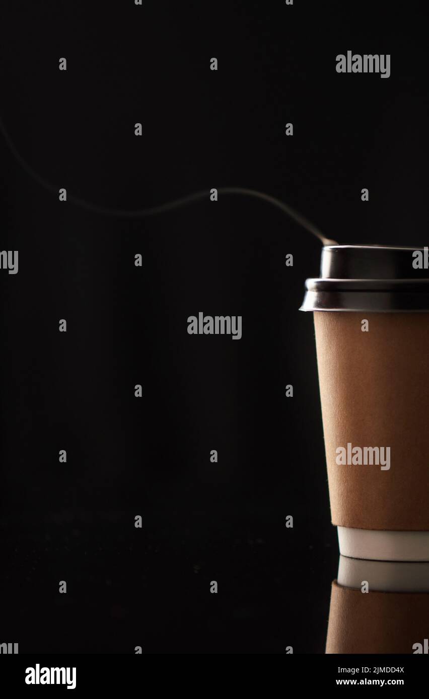 Grab a cup to go. Closeup shot of steam rising from a paper cup filled ...