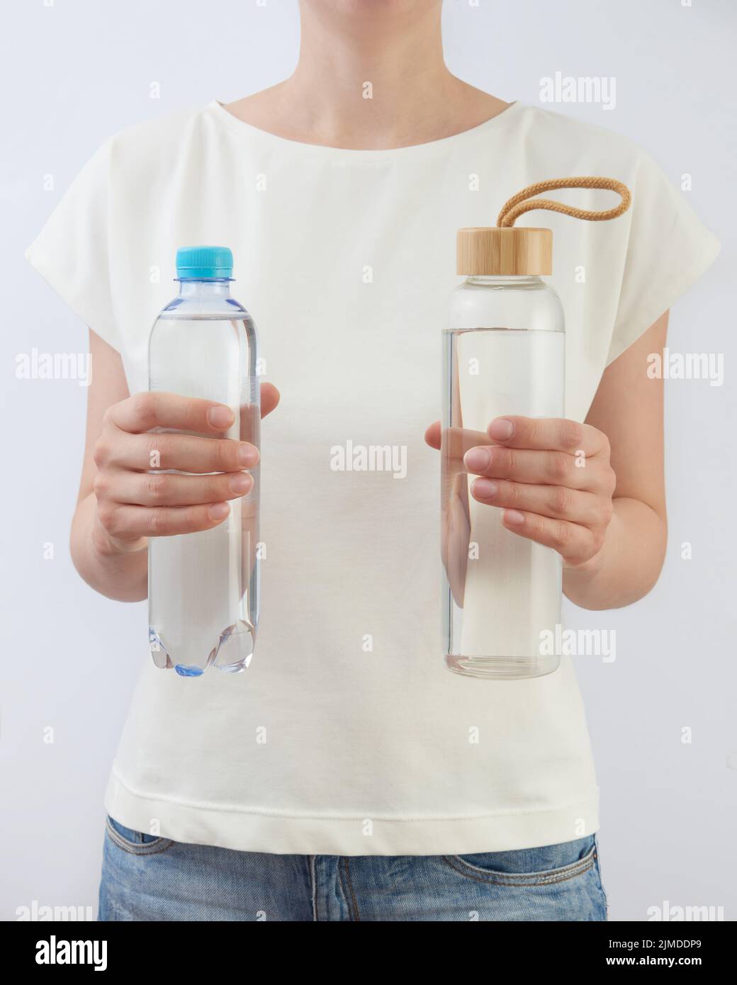 Two water bottles in hand hi-res stock photography and images - Alamy