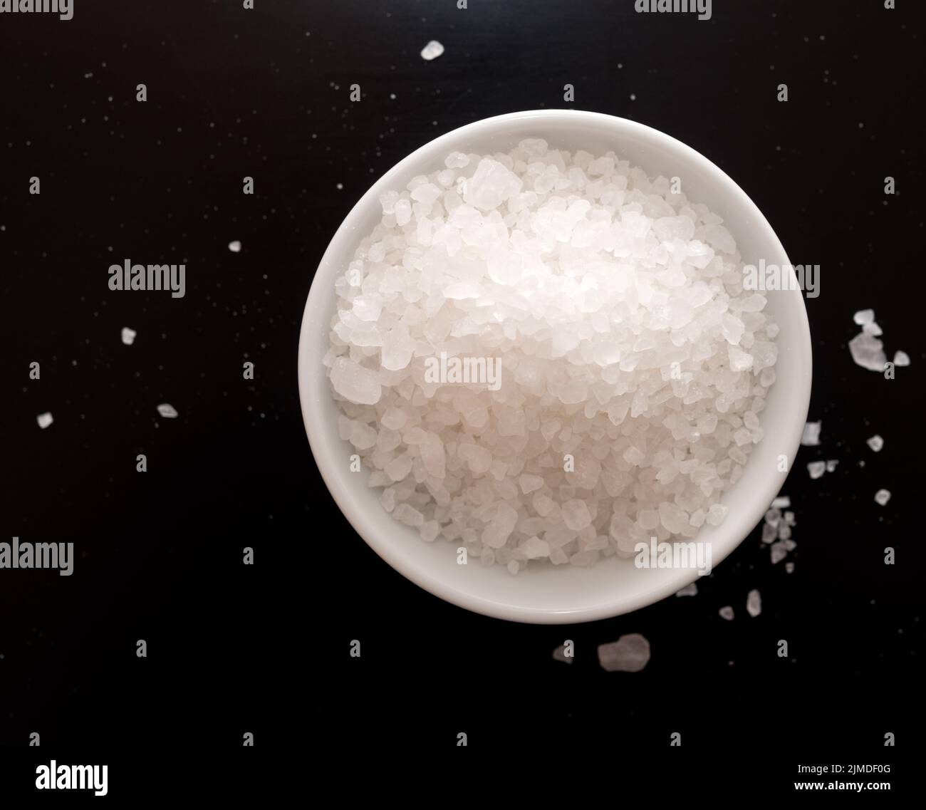 Salt on black Stock Photo - Alamy