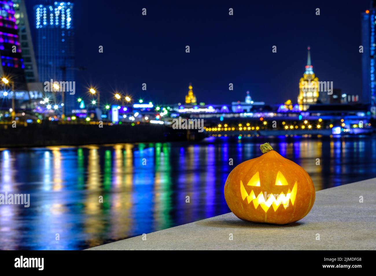 Halloween pumpkin on the background of the night city. Multi-storey ...