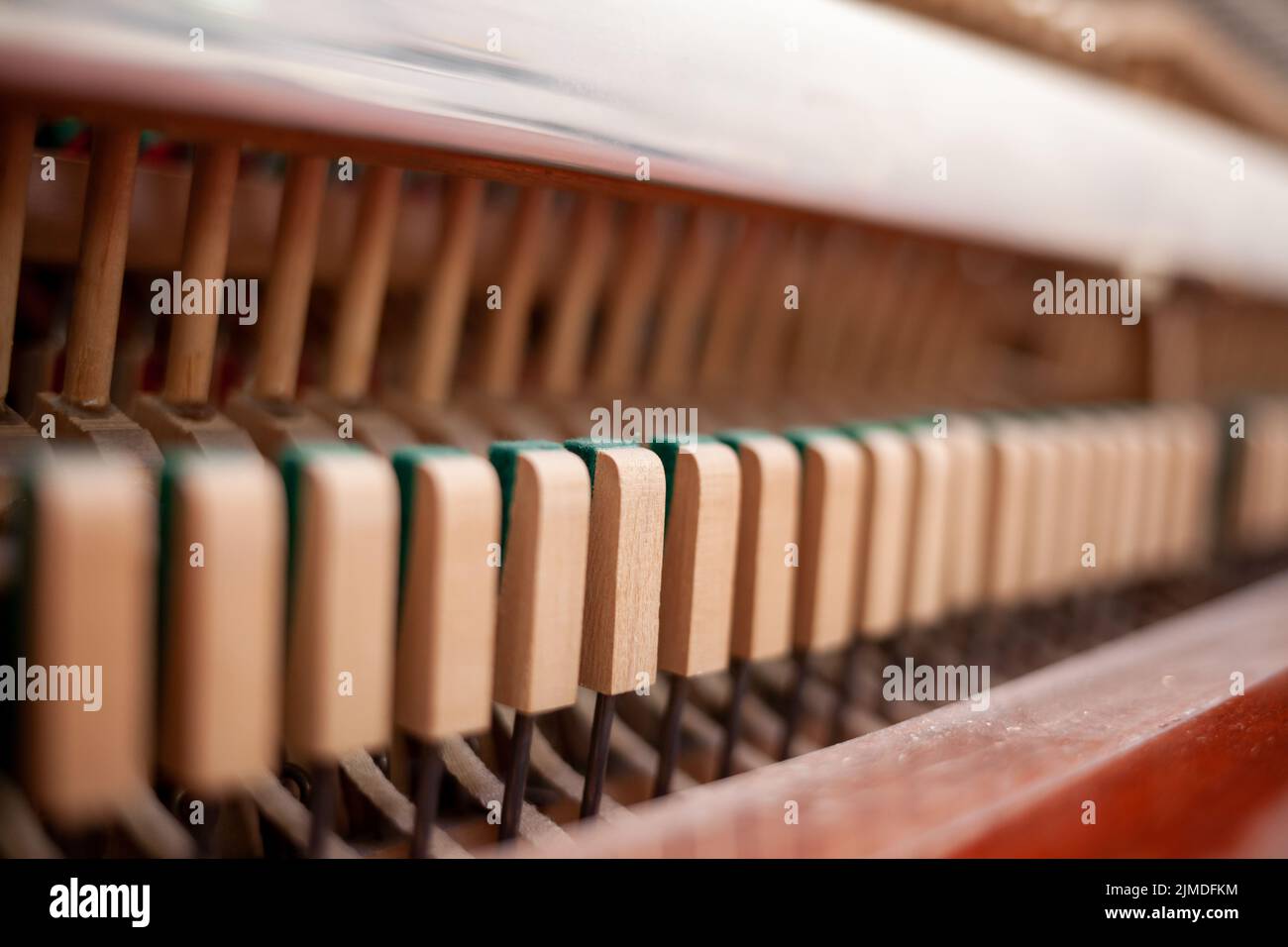 The inside of the piano is without a lid. Strings, hammers and other ...
