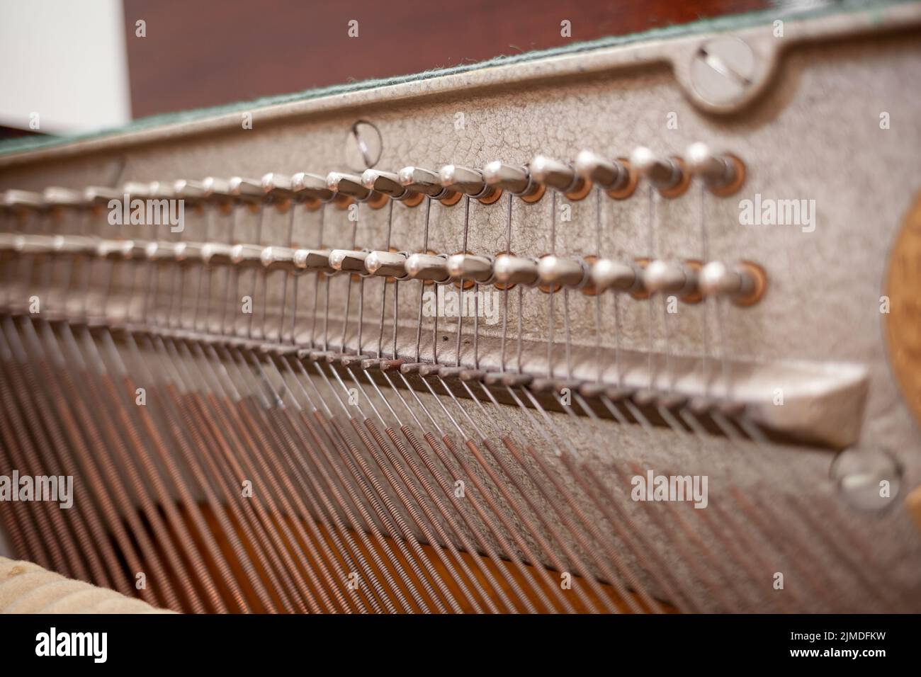 The inside of the piano is without a lid. Strings, hammers and other ...