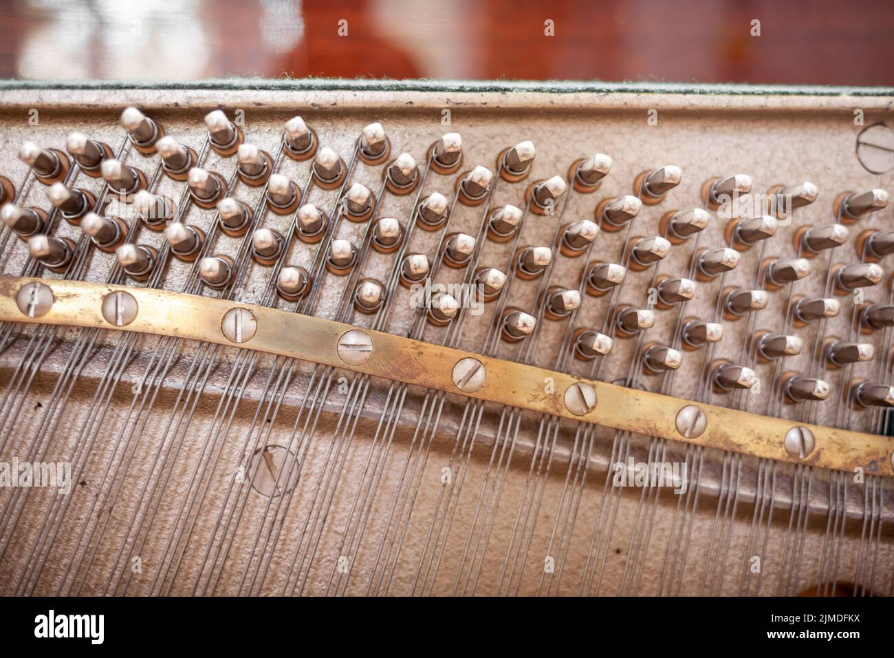 The inside of the piano is without a lid. Strings, hammers and other ...