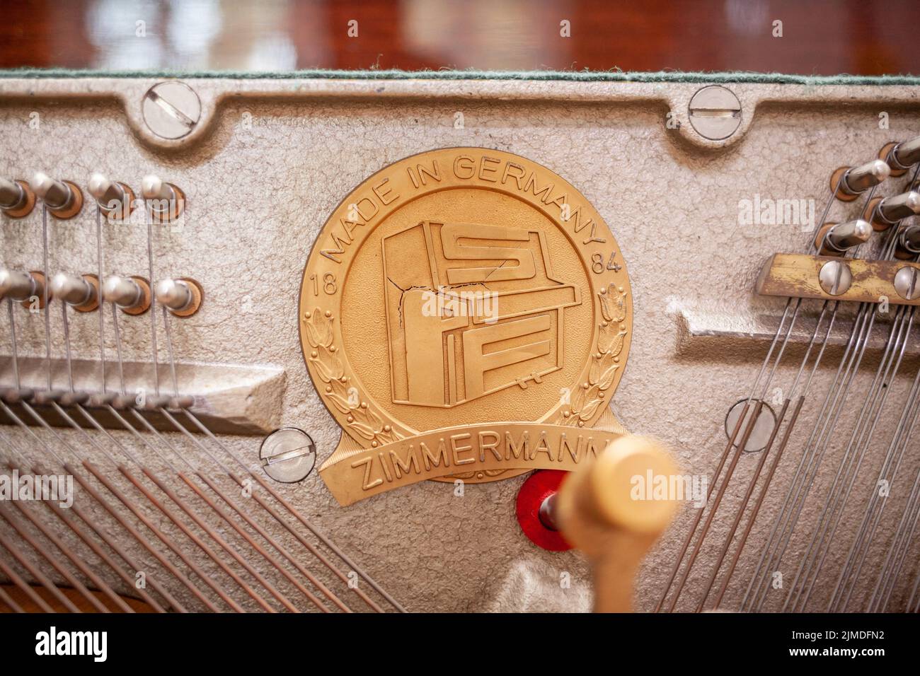 The inside of the piano is without a lid. Strings, hammers and other ...