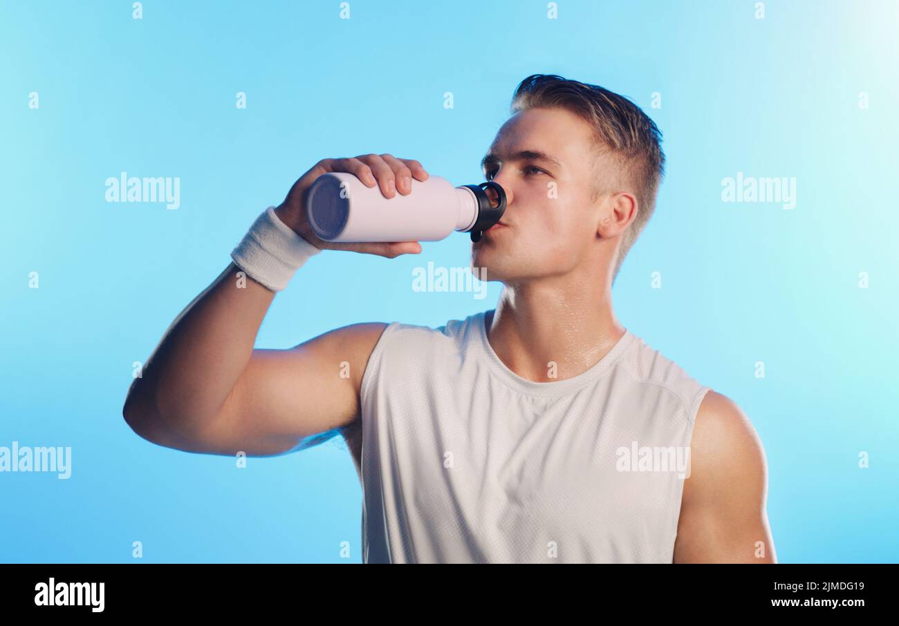 Staying hydrated throughout his workout. Studio shot of a handsome ...