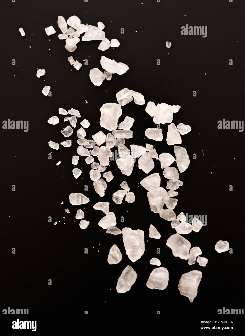 Salt on black Stock Photo - Alamy