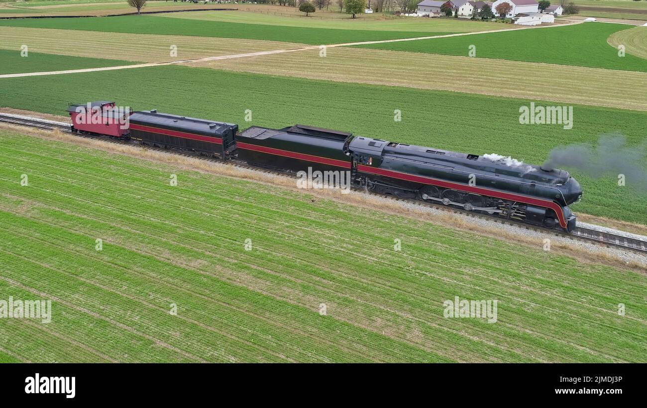 Aerial View of a Restored Antique Steam Locomotive Pulling a Caboose ...