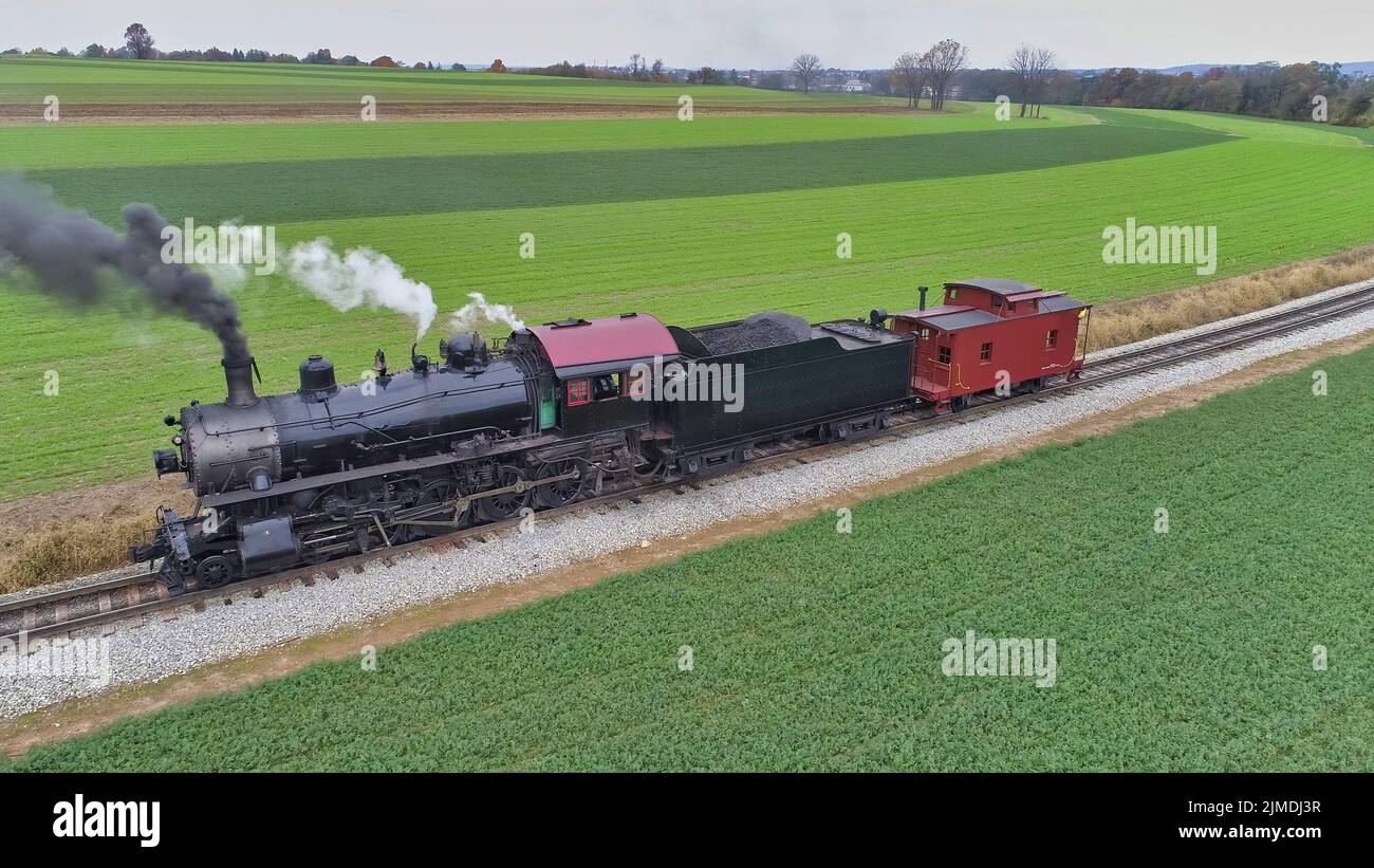 Aerial View of a Restored Antique Steam Locomotive Pulling a Caboose ...