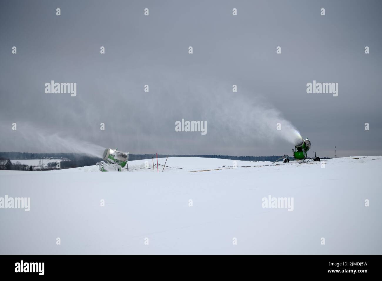 Snow making machine on the ski slope in winter. Spraying snow powder ...