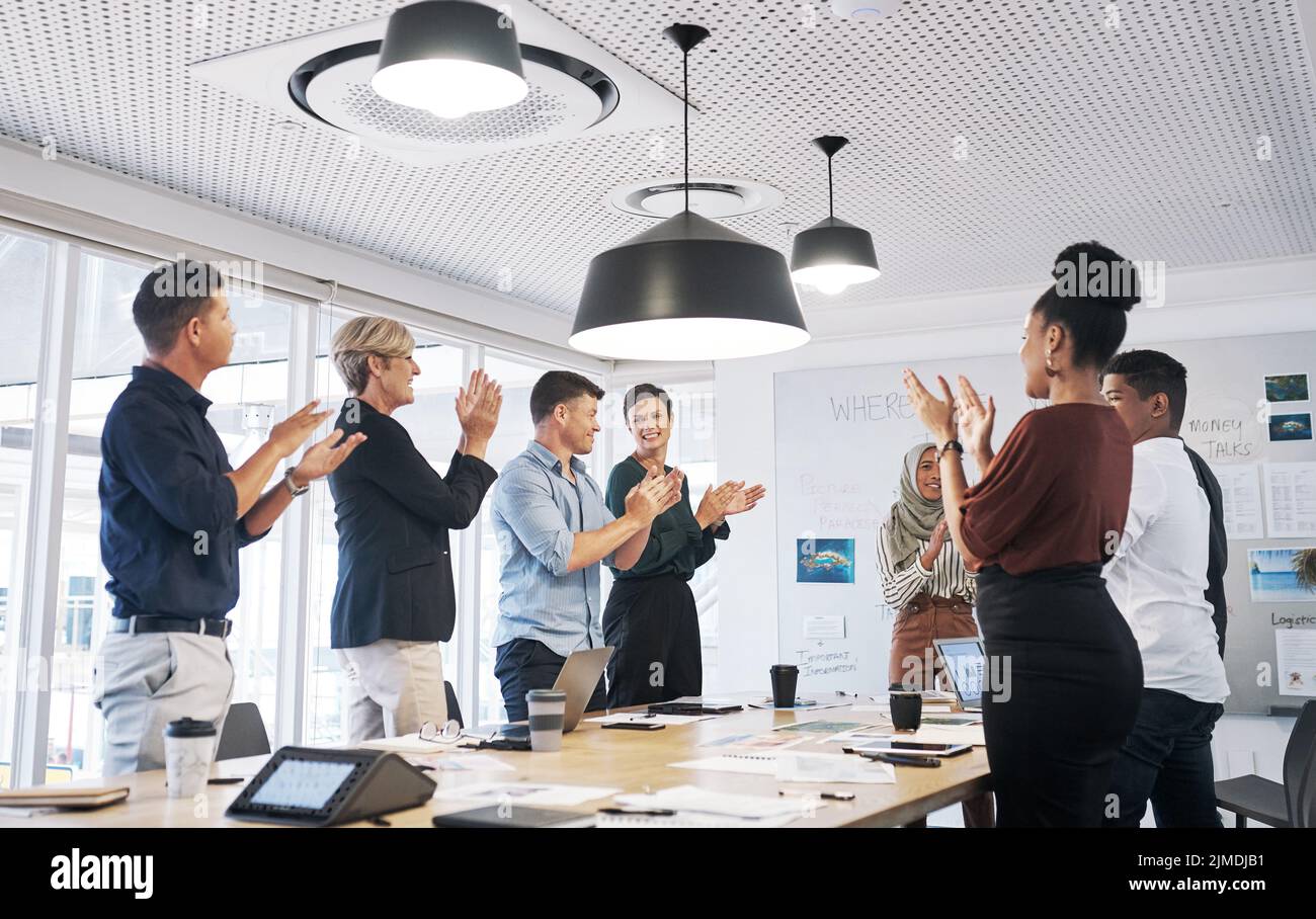 Outstanding achievements all round. a group of businesspeople clapping ...