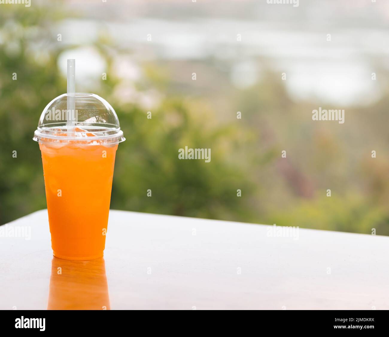 Glass of orange juice on the table outdoor Stock Photo - Alamy