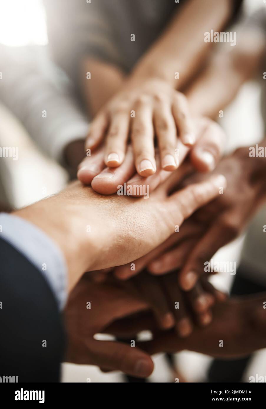 Hands of group of corporate business people in unity for motivation ...