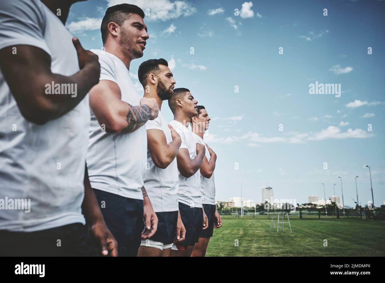 Stand for attention. a team of confident young rugby players standing ...