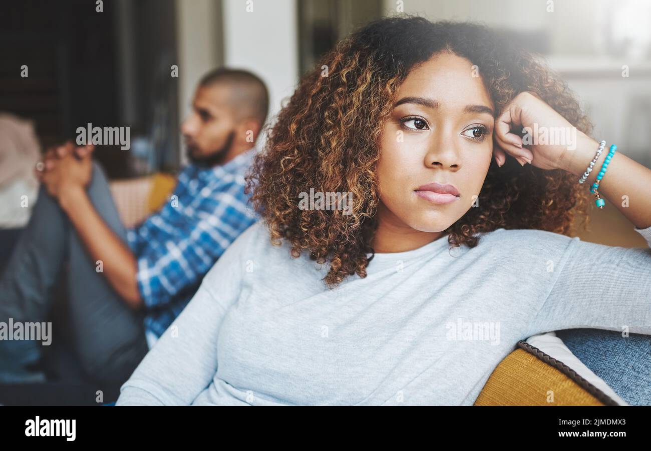 Unhappy Angry And Stressed Couple Sitting On A Sofa Together After