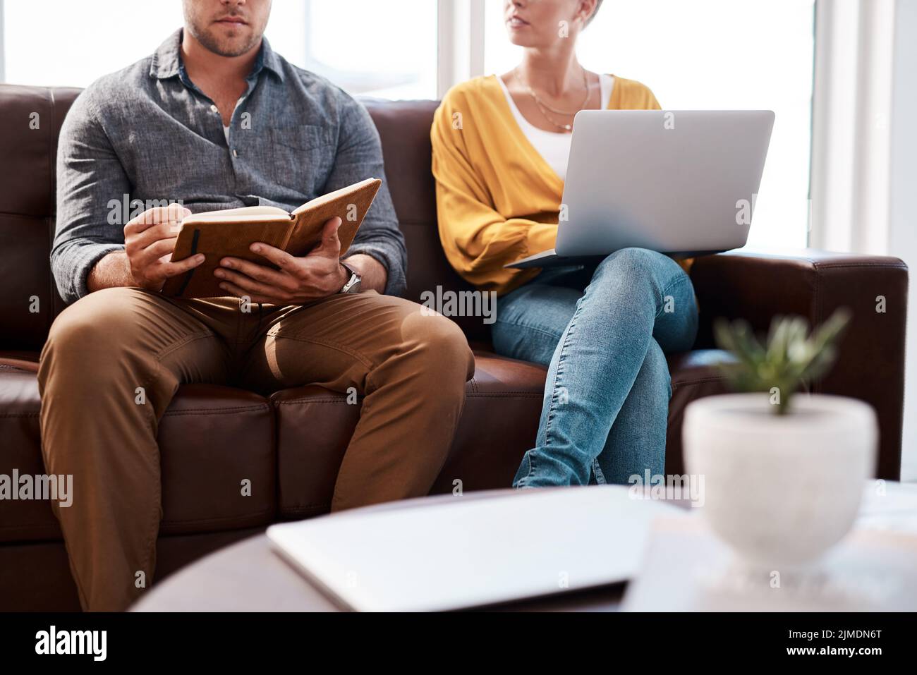 Getting comfy to get creative. Closeup shot of two unrecognisable businesspeople having a ...