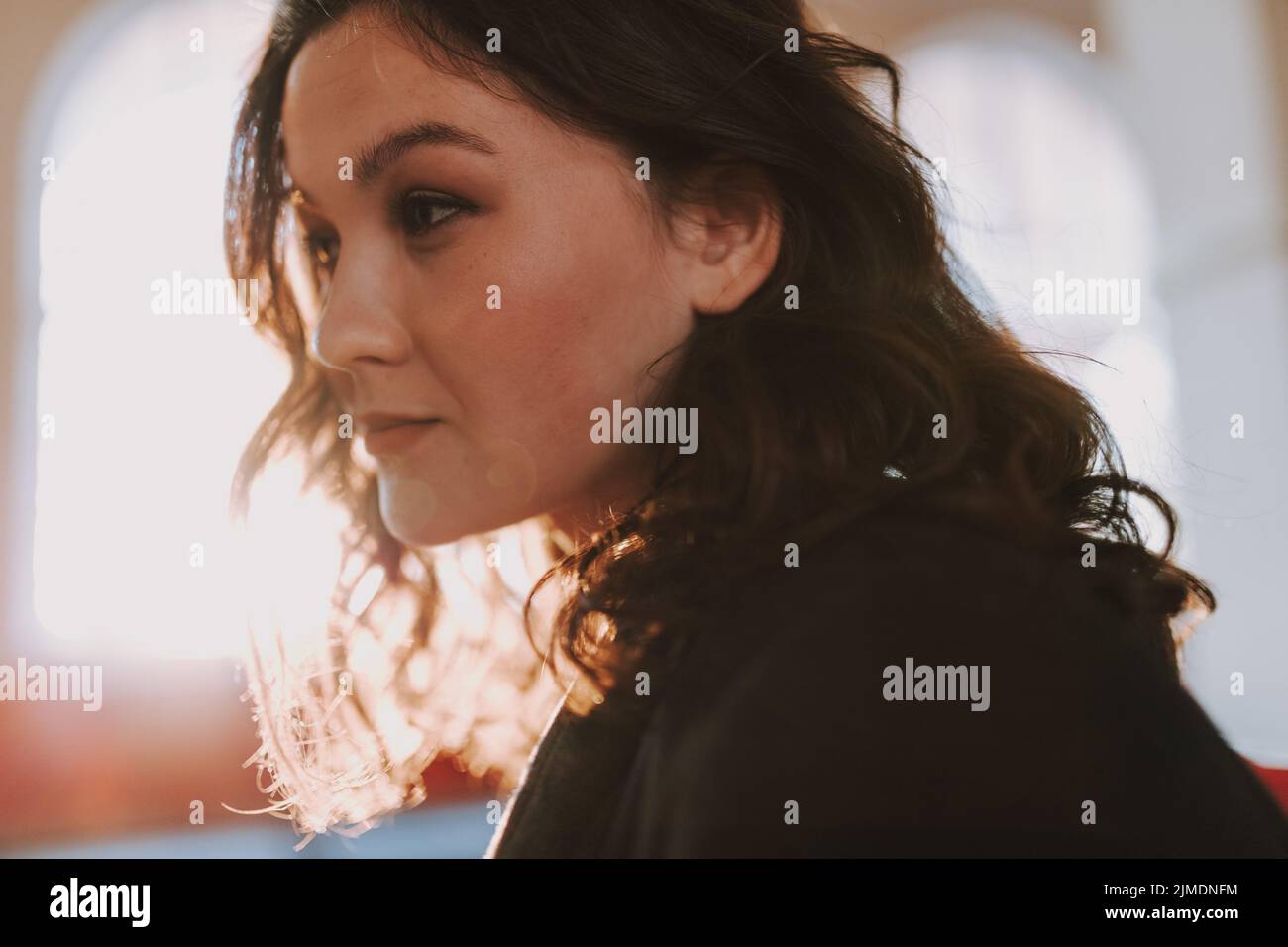 Pretty young brunette lady looking in front of herself Stock Photo - Alamy