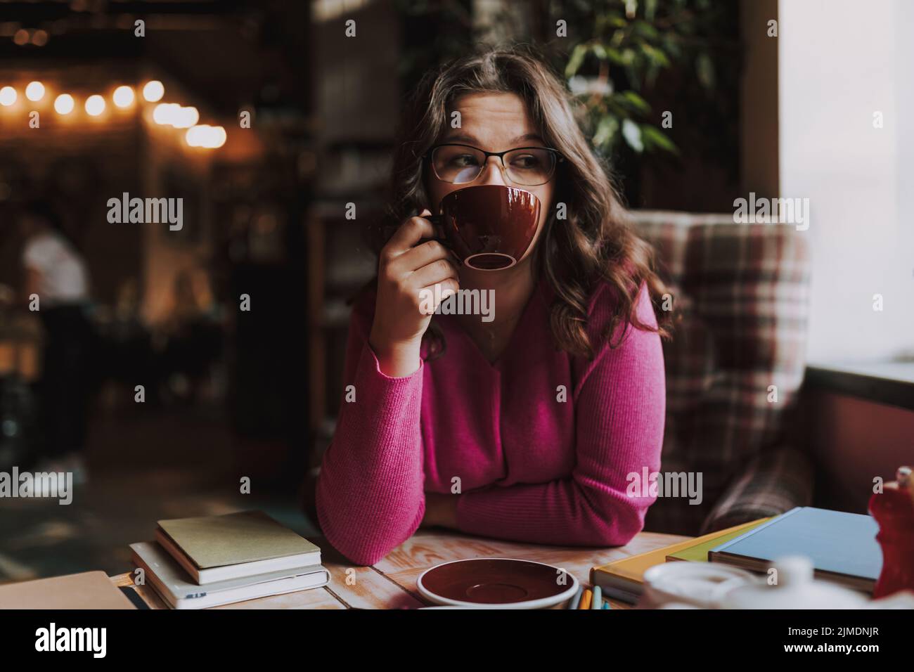 Cute female sitting in cafeteria hi-res stock photography and images ...