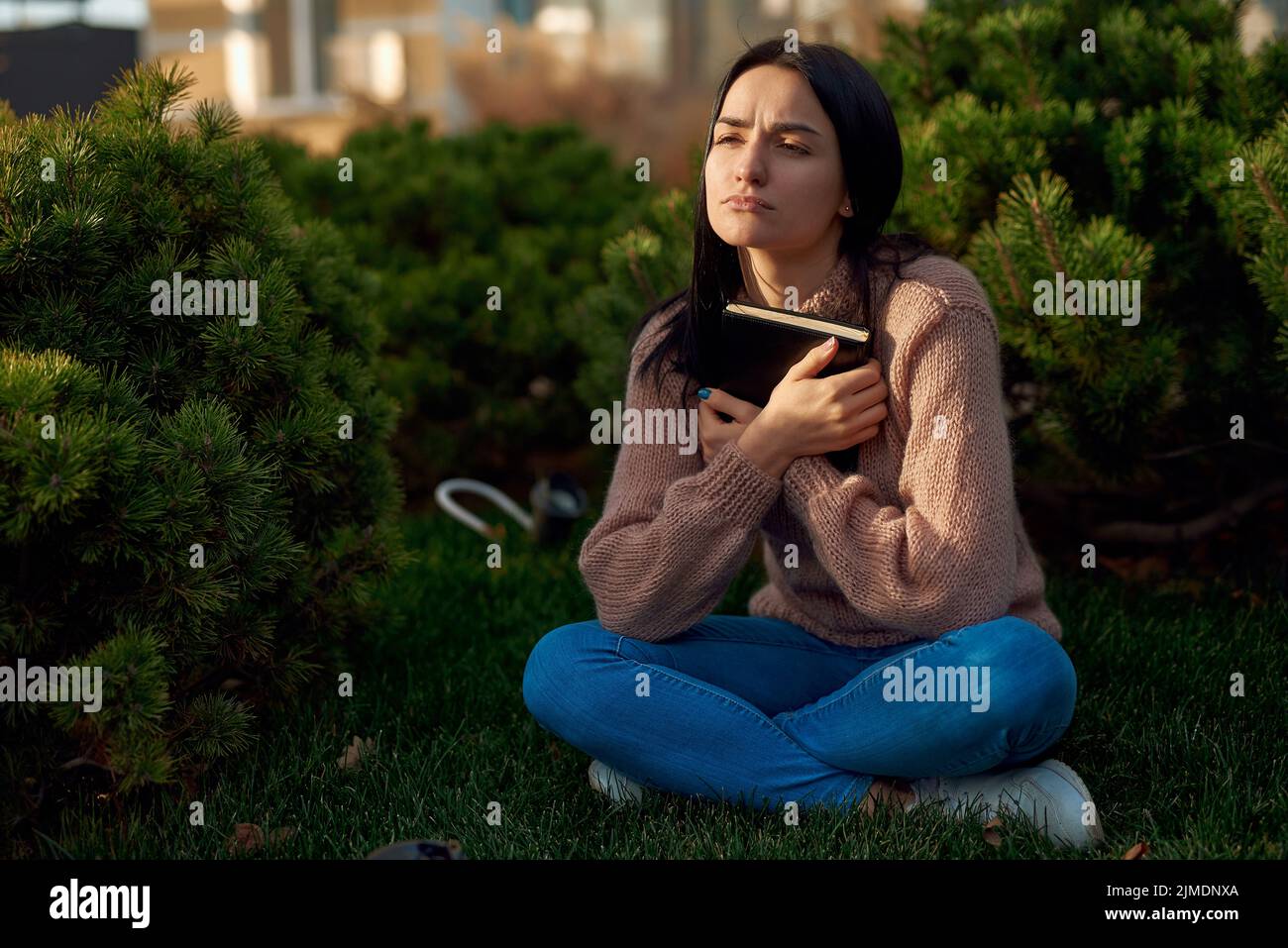 Serious young lady sitting hi-res stock photography and images - Alamy