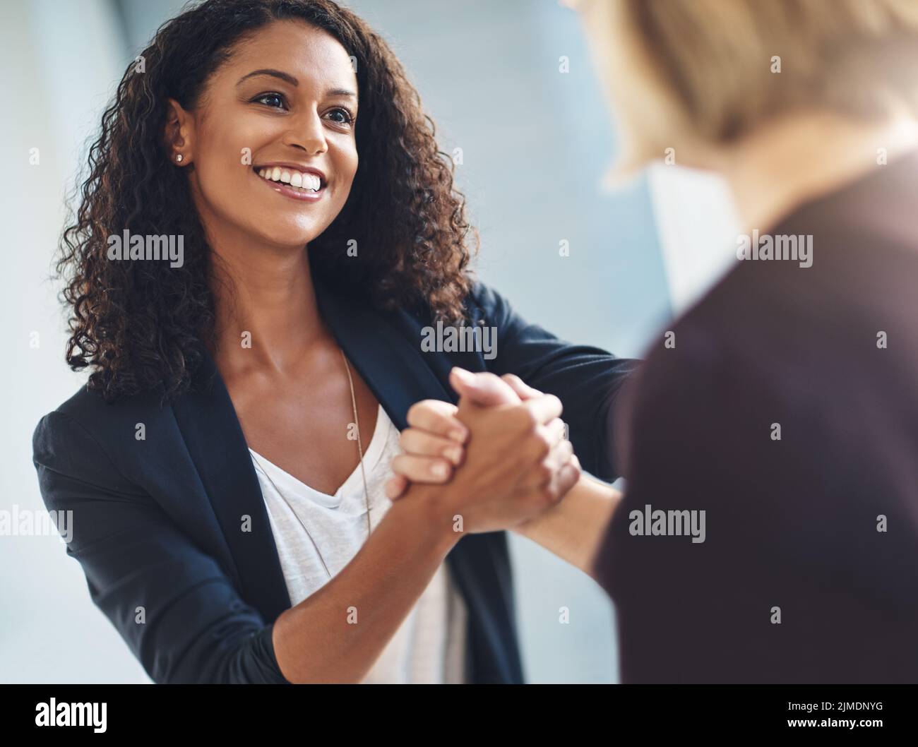 Happy and diverse corporate business women giving handshake, welcoming ...