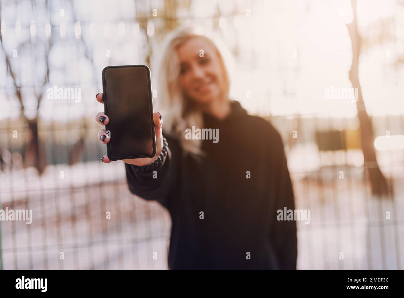 Young woman showing mobile hi-res stock photography and images - Alamy