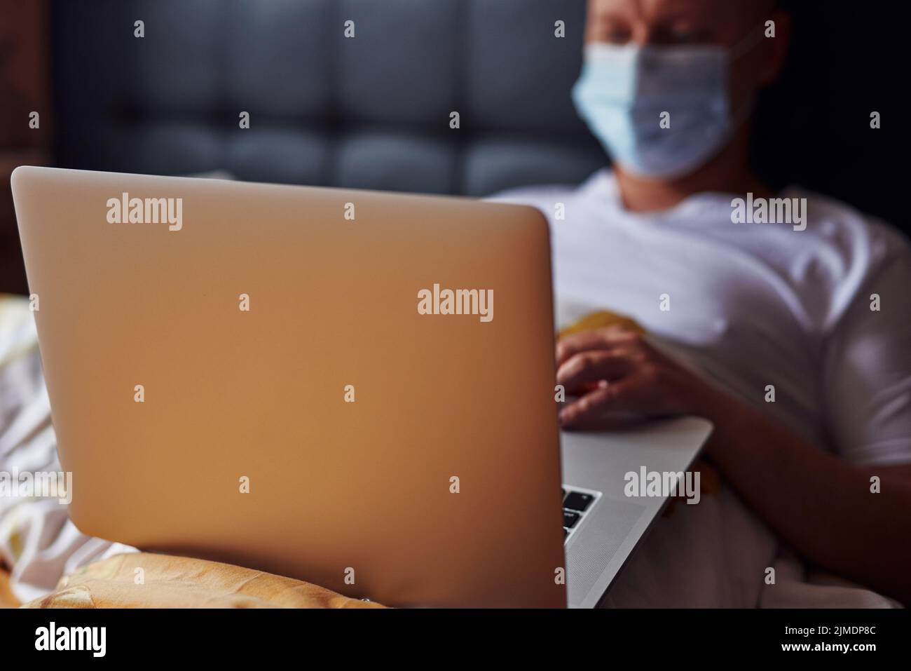 The patient working from home in bed. Teleworking concept. Home office ...