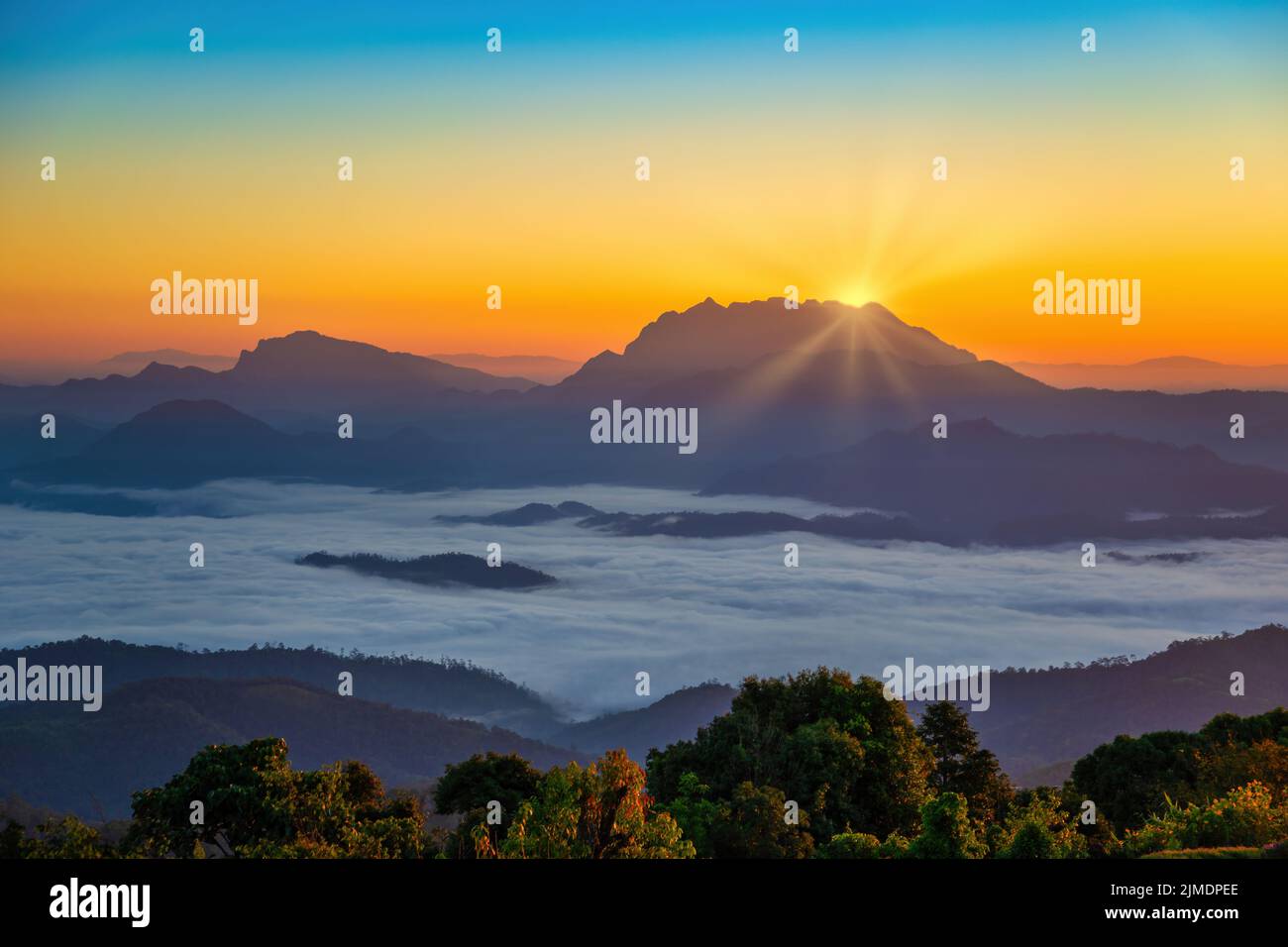 Tropical forest nature landscape view with mountain range sunrise with moving cloud mist at Huai ...