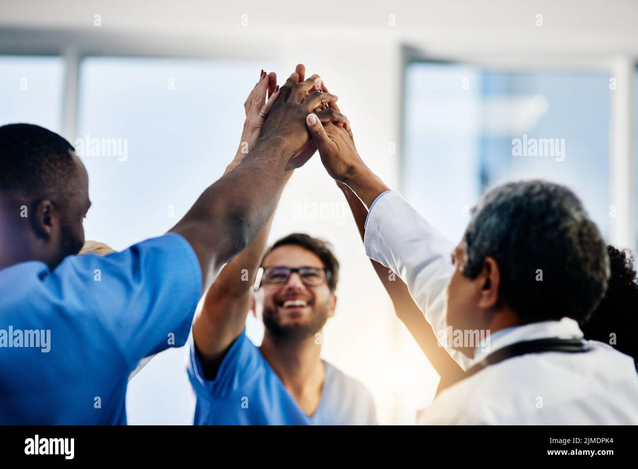 Doctors celebrating medical success after working together as a team ...