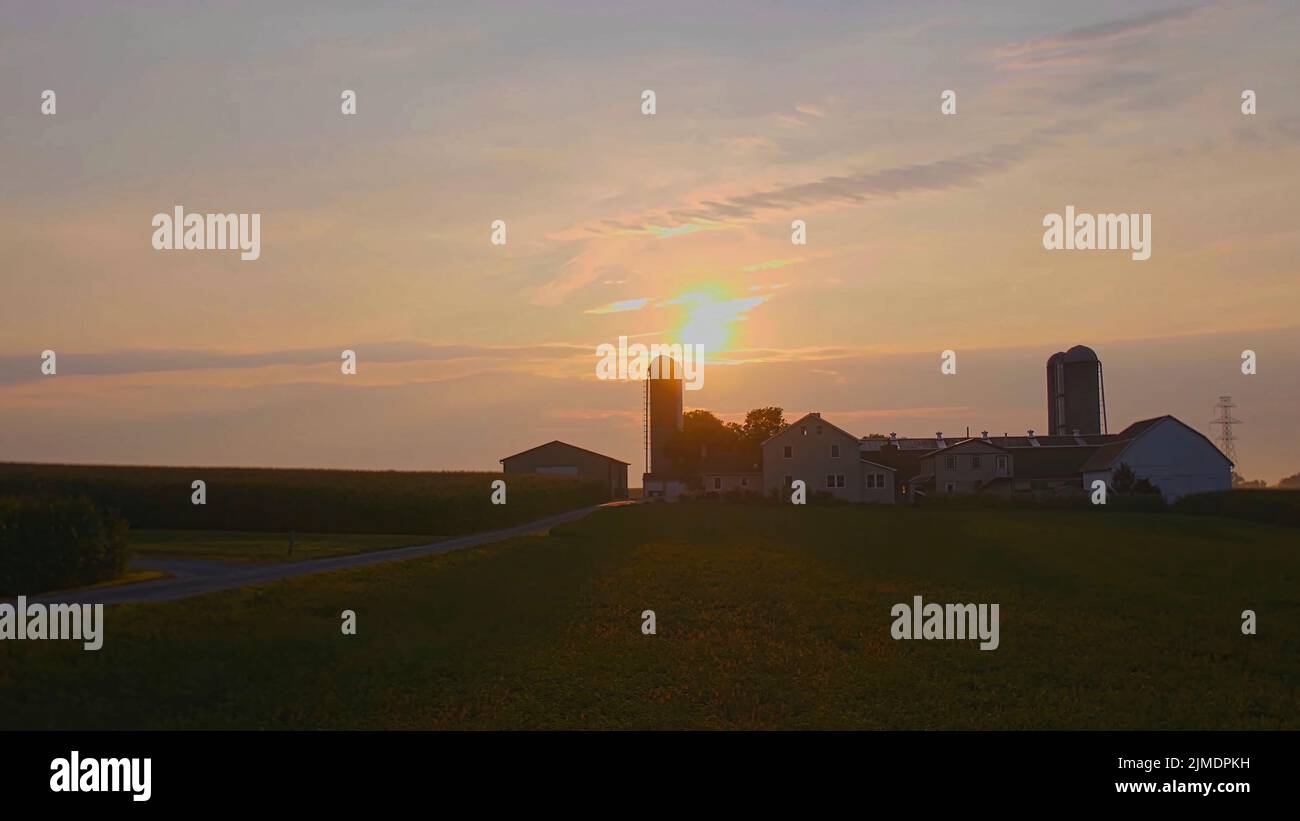 Sunrise Looking over an Amish Farm with Farm House Barn and Silos Stock ...