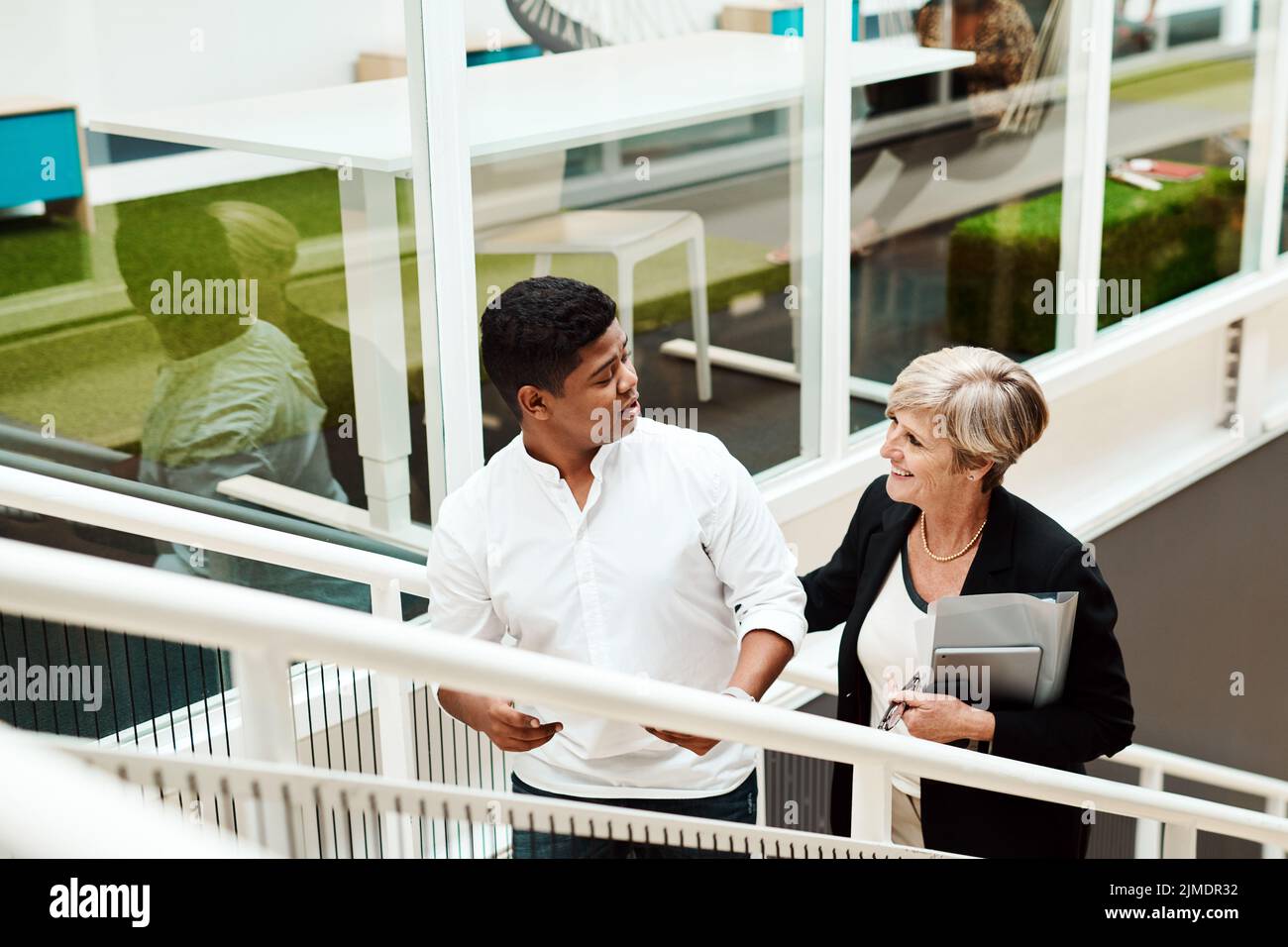 Moving up and straight towards success. two businesspeople walking up a ...