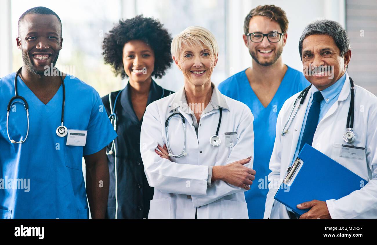 Team or group of a doctor, nurse and medical professional colleagues or coworkers standing in a ...