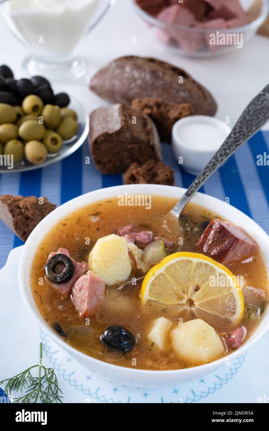 Traditional Russian soup Solyanka cooked with meat, sausages, salted ...