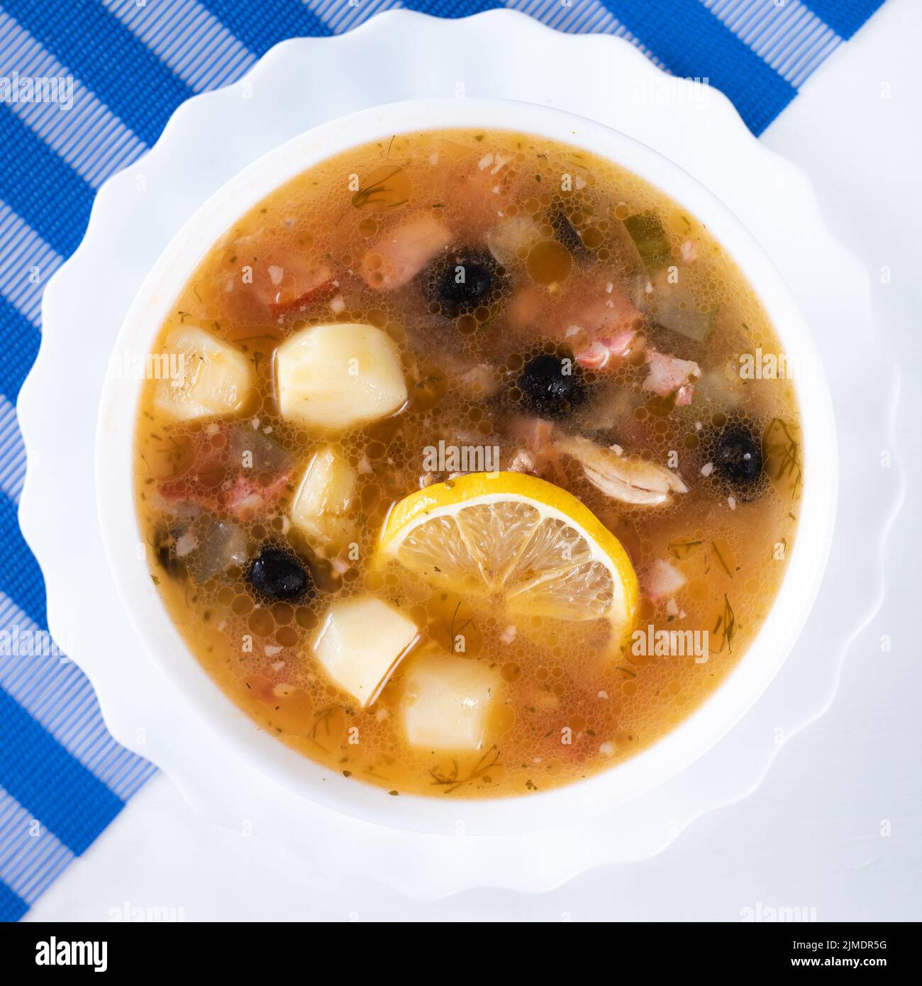 Traditional Russian soup Solyanka cooked with meat, sausages, salted ...