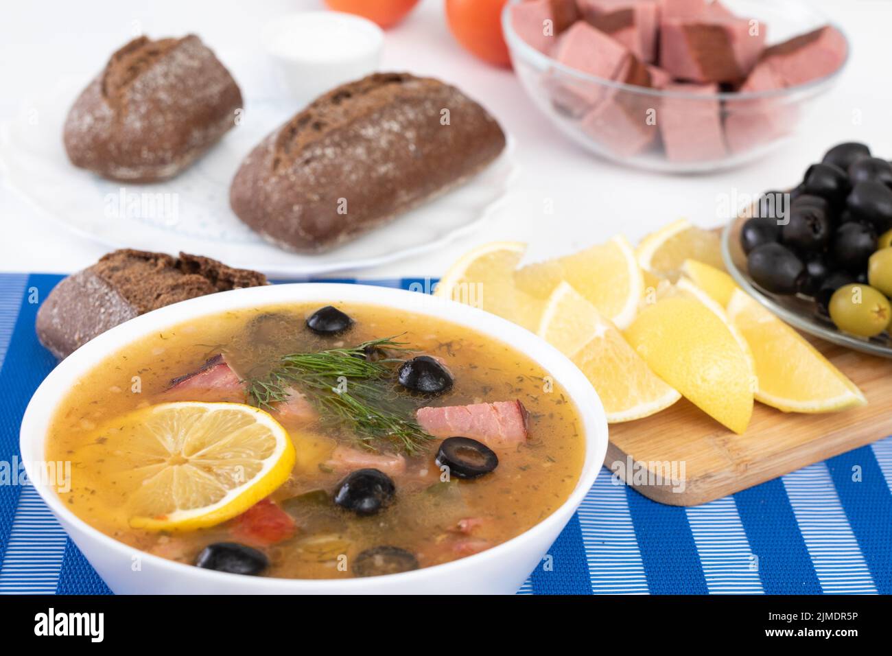 Traditional Russian soup Solyanka cooked with meat, sausages, salted ...
