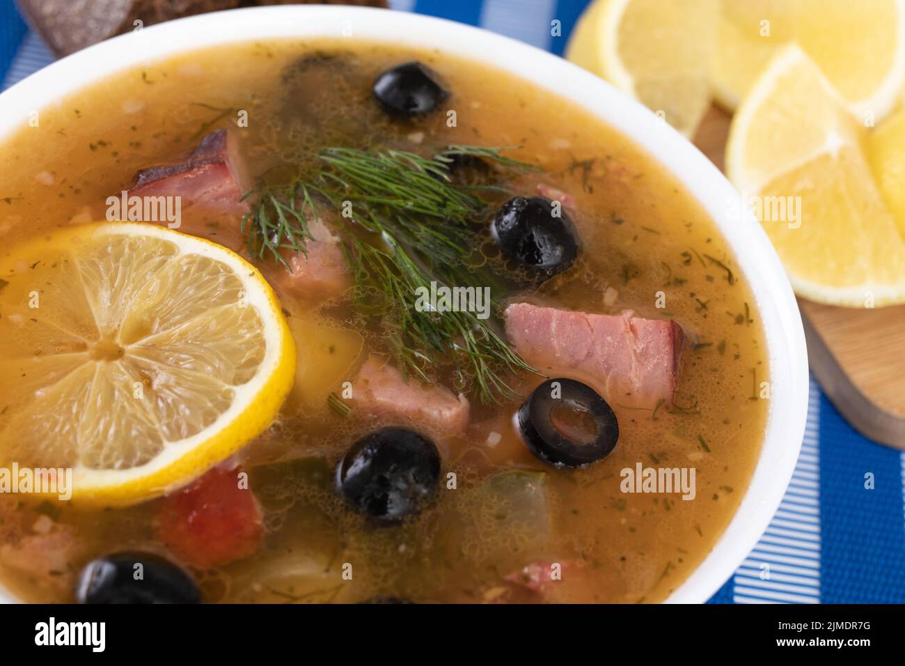Traditional Russian soup Solyanka cooked with meat, sausages, salted ...