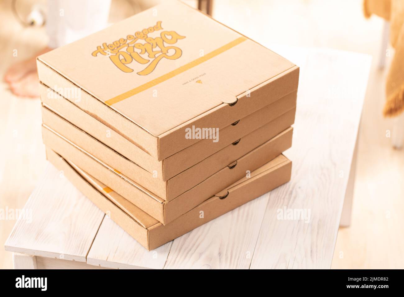 Pizza box, stack, brown, front view. on the dining table Stock Photo ...