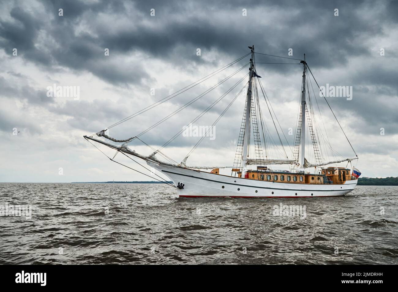 Antique sailing frigate of white color to the sea, the lowering storm ...