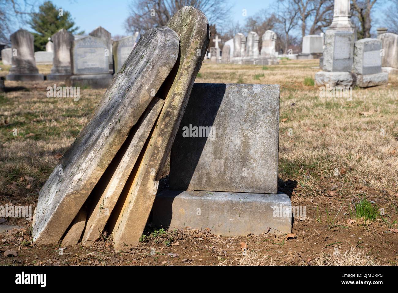 A stack of broken tombstones in a cemetery Stock Photo - Alamy