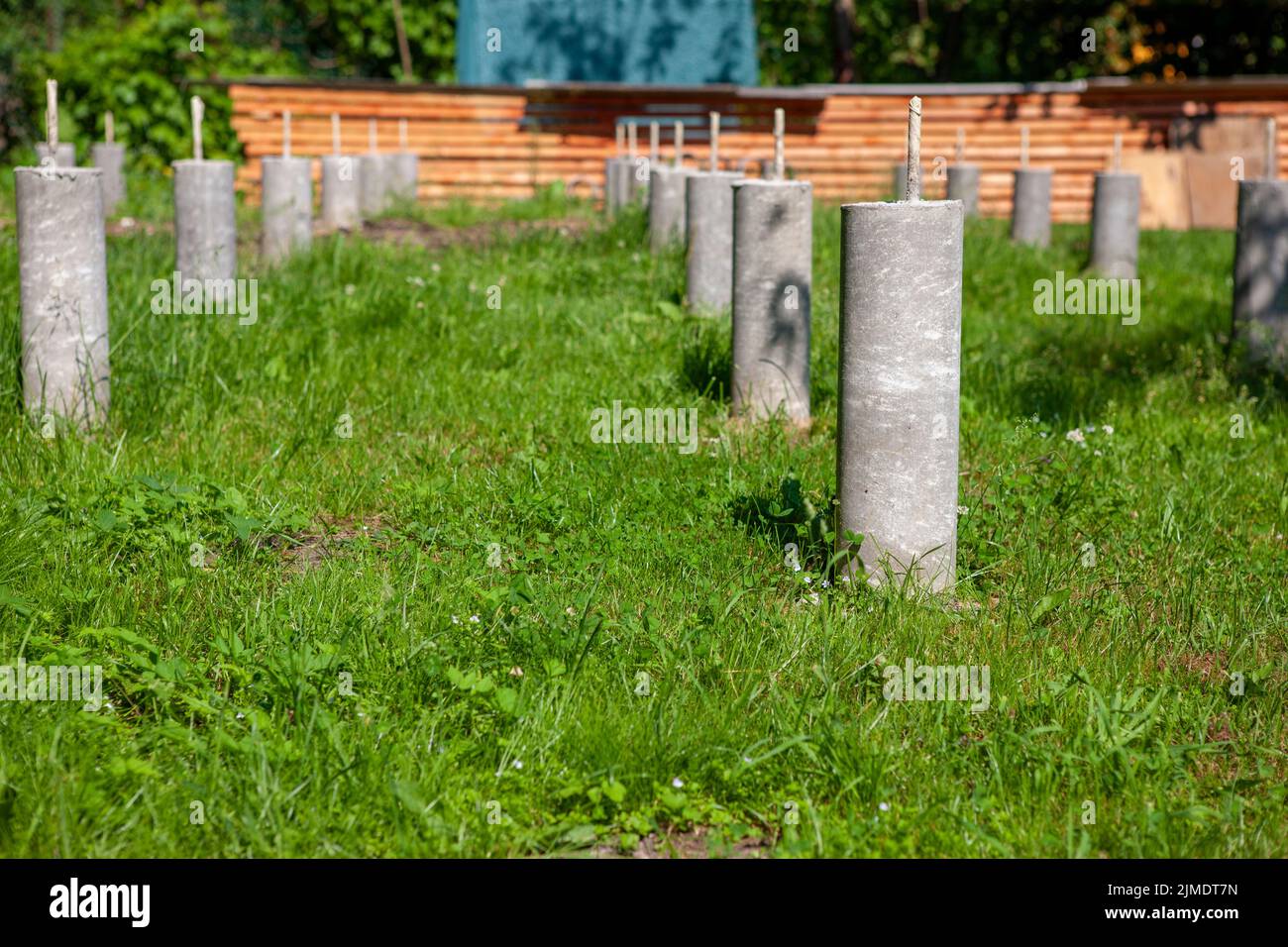 new cement posts for foundation constrcution, summertime outdoor shot ...