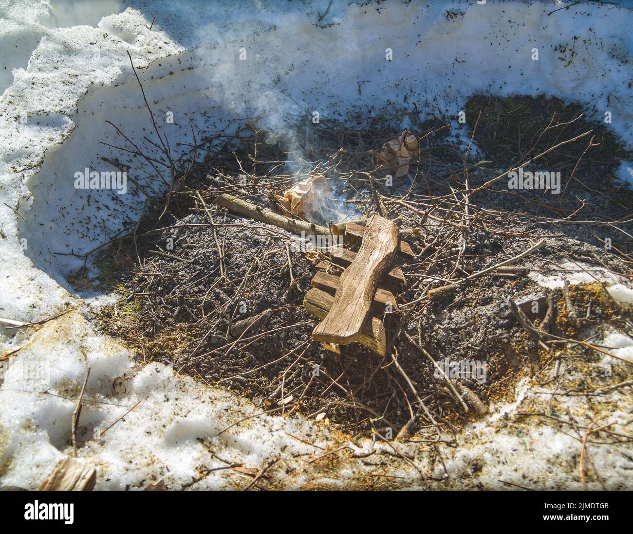 extinguished campfire and melted snow around, winter scene Stock Photo ...