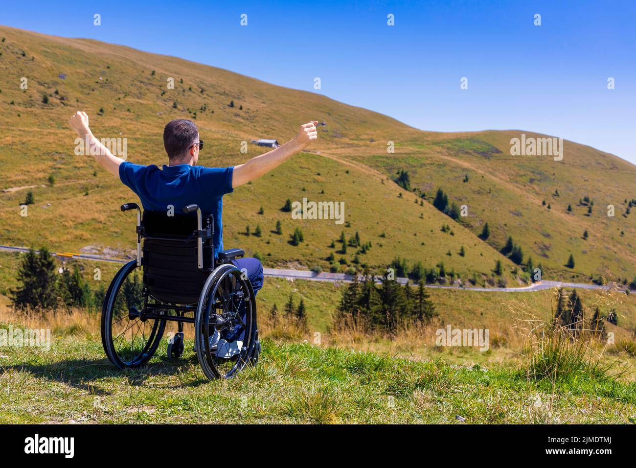 Optimistic handicapped man sitting on wheelchair Stock Photo - Alamy