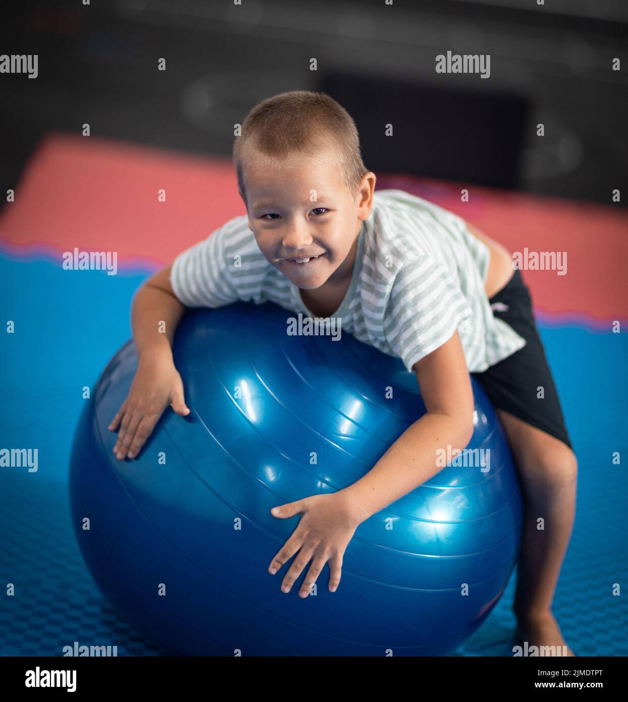 Boy doing exercises with ball Stock Photo - Alamy