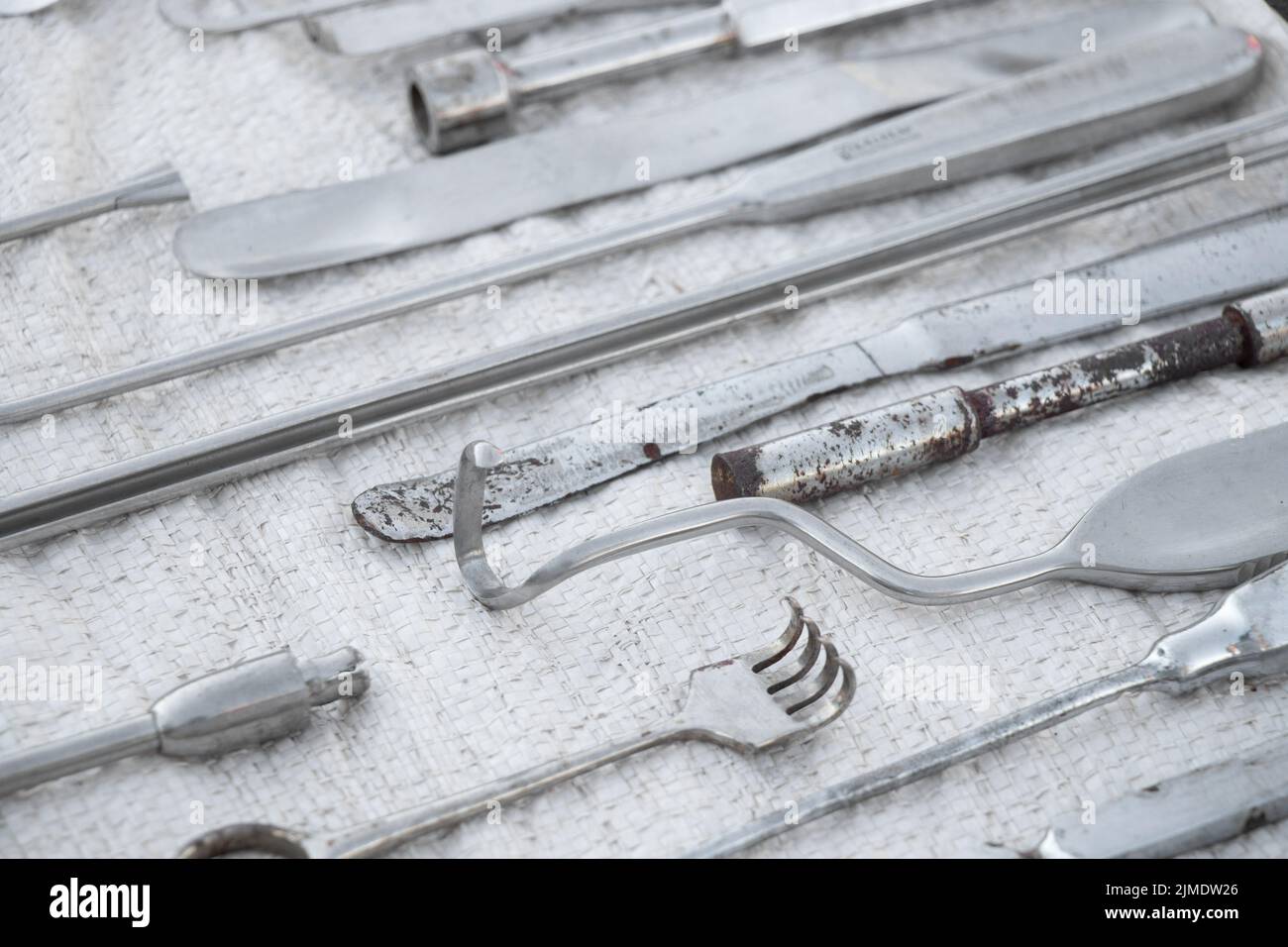 set of old medical instruments clamps ,scalpels and scissors on a white ...