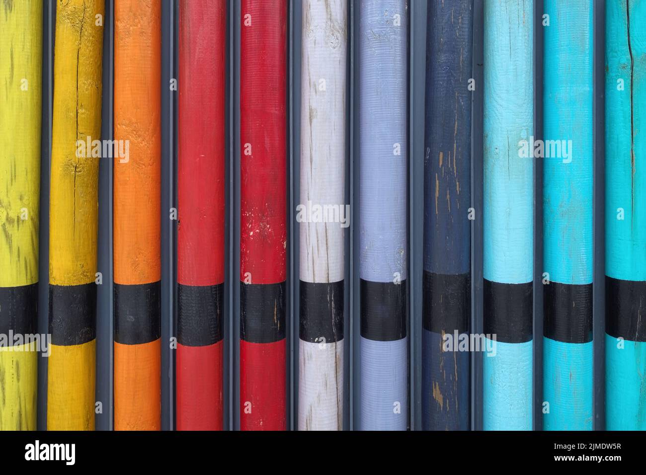Colorful wooden poles as part of an enclosure, Germany Stock Photo - Alamy
