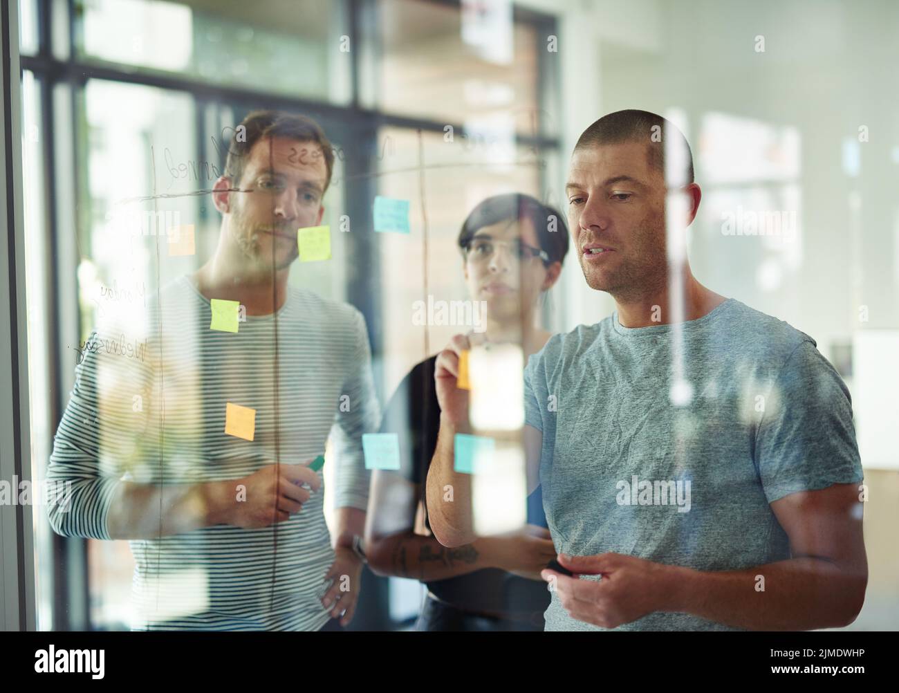 Businesspeople in brainstorm, thinking and planning session in a modern ...