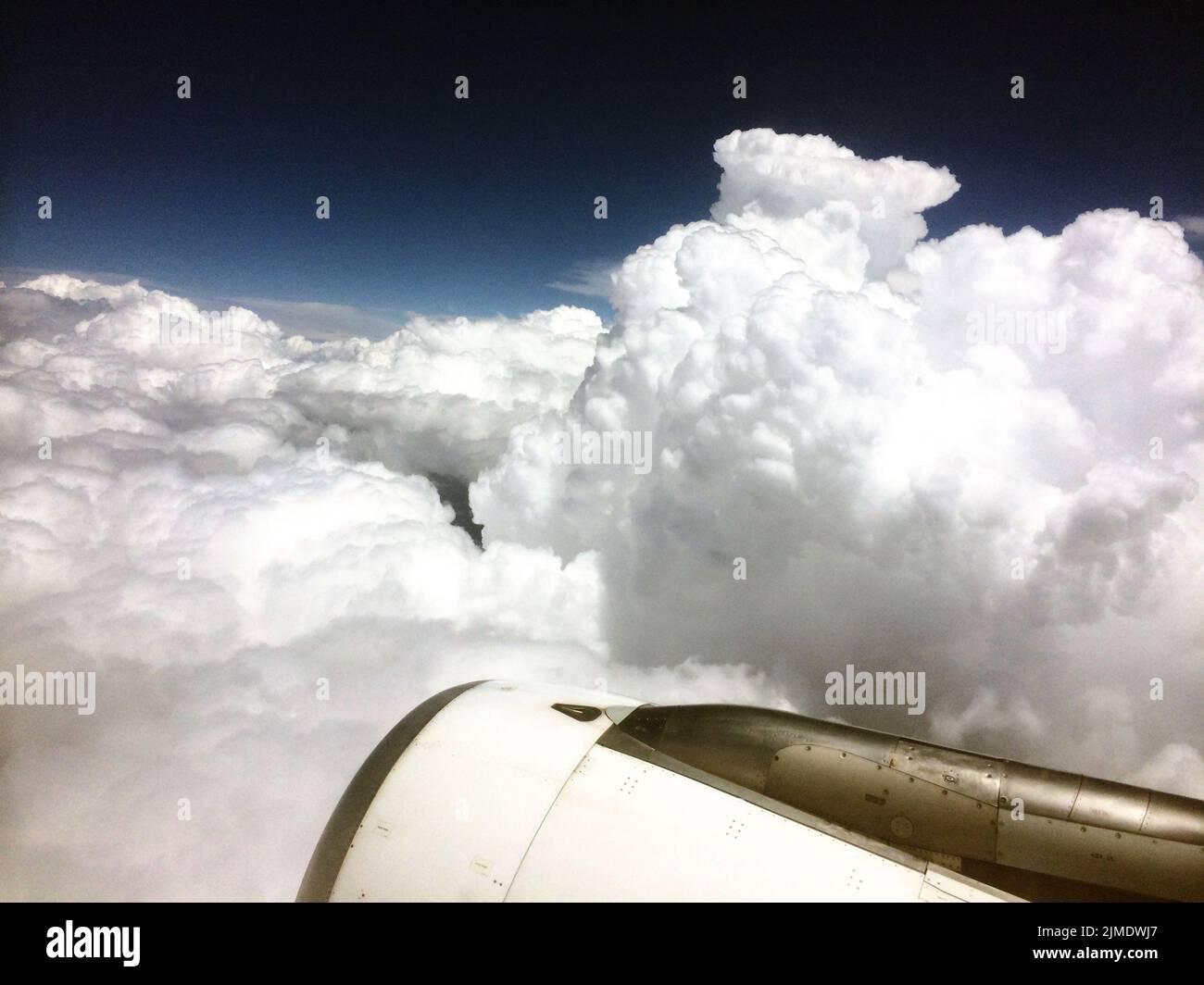 A beautiful cloudy night view from the window of an airplane with the ...
