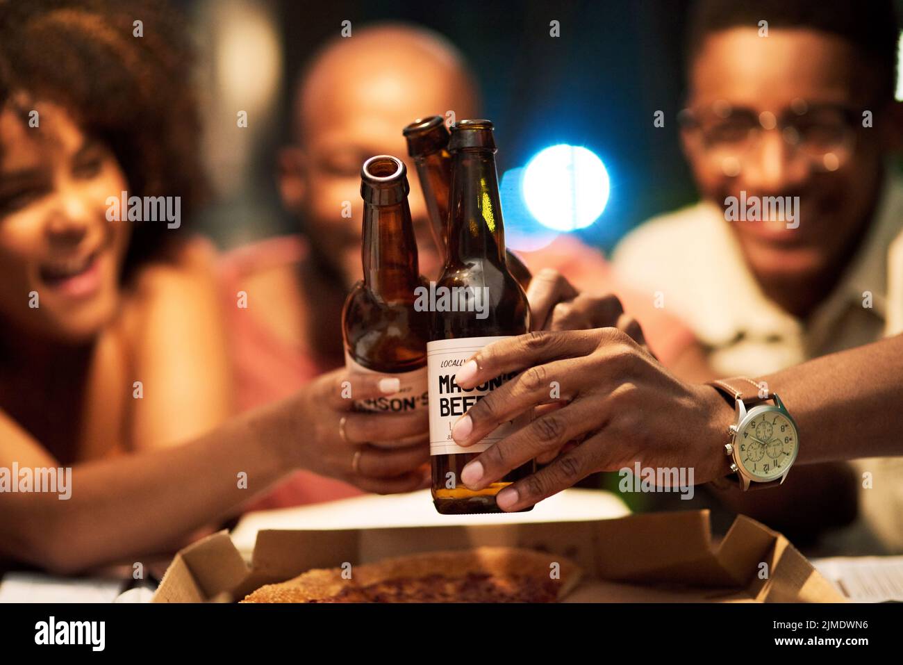 Lets drink to our success. a group of businesspeople having beers at ...